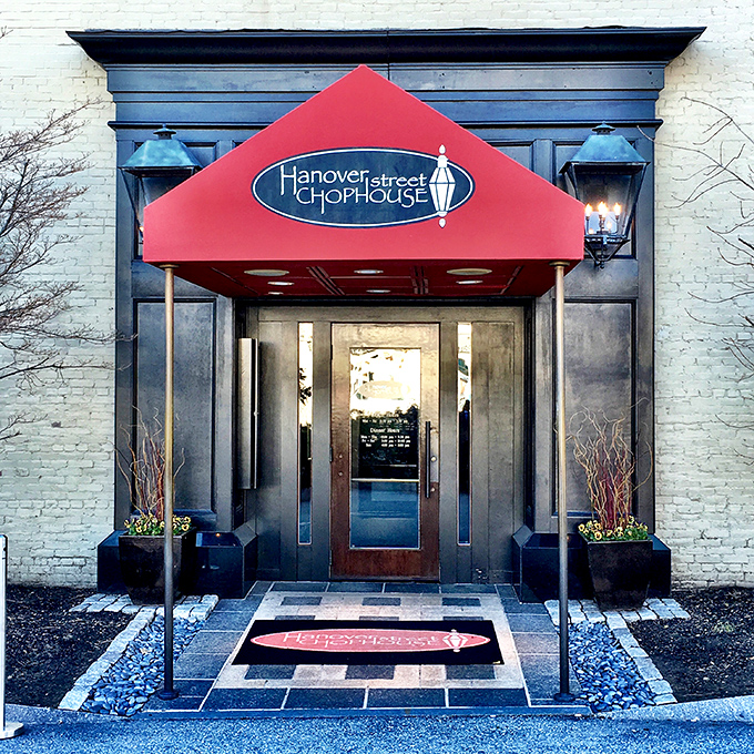 The iconic red awning beckons like a culinary lighthouse, promising refuge from ordinary dining experiences in downtown Manchester.