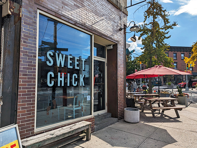 The unmistakable pink brick exterior of Sweet Chick beckons hungry passersby with its warm glow and picnic tables that practically whisper, "Pull up a seat, friend."