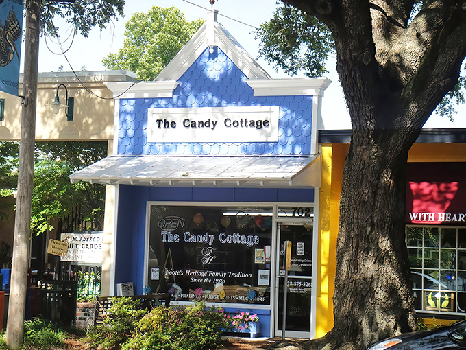 The blue cottage beckons like a sweet mirage among Ocean Springs' oak trees, promising childhood memories and sugar-fueled adventures inside.