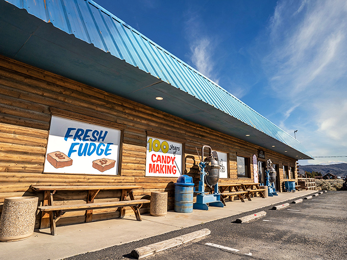 The rustic log cabin exterior of Chocolate Nugget beckons like a sweet mirage in the Nevada desert, complete with picnic tables for immediate sugar-rush recovery.