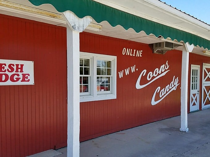 The iconic red exterior of Coons Candy beckons like a barn-sized treasure chest. Even the "FRESH FUDGE" sign seems to whisper sweet promises from across the parking lot.