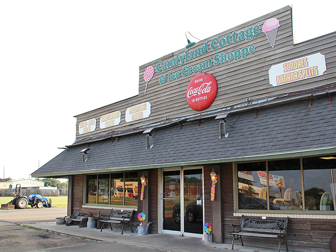 The charming exterior of Candyland Cottage beckons like a sweet mirage in Rayne, promising sugar-fueled nostalgia behind those vintage windows.