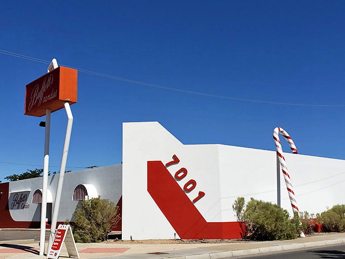 The red and white exterior of Buffett's Candies stands like a sweet mirage in the desert, promising sugary salvation to Albuquerque's candy pilgrims.