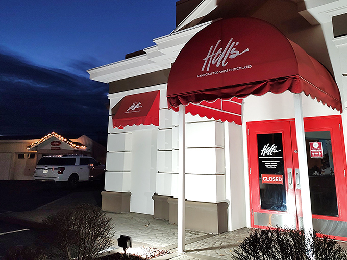 The iconic red awning of Holl's beckons chocolate lovers like a Swiss flag signaling delicious neutrality in the battle against willpower.