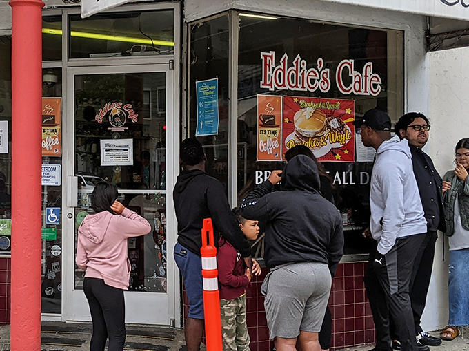 The sidewalk pilgrimage begins. Eddie's iconic storefront has been stopping San Franciscans in their tracks for generations, with a line that's practically a neighborhood ritual.