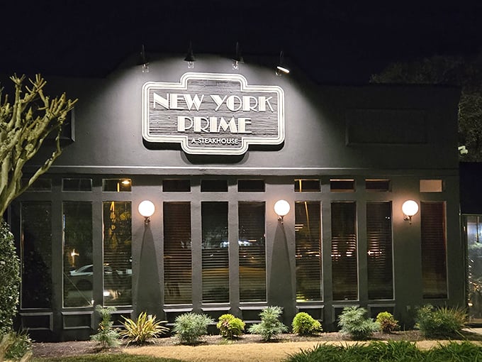 The illuminated sign of New York Prime glows like a beacon for carnivores, promising an escape from the ordinary beach fare that surrounds it.
