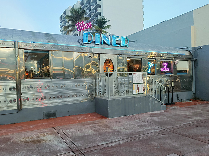The gleaming stainless steel exterior of 11th Street Diner shines like a beacon of nostalgia under Miami's blue skies, promising comfort food and air conditioning in equal measure.