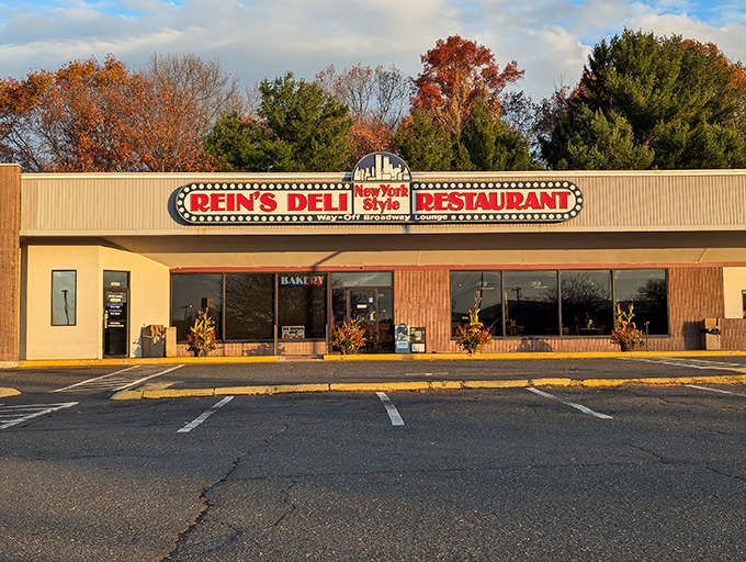 The iconic Rein's Deli sign glows like a beacon for hungry travelers on I-84, promising authentic New York deli magic in the heart of Connecticut.