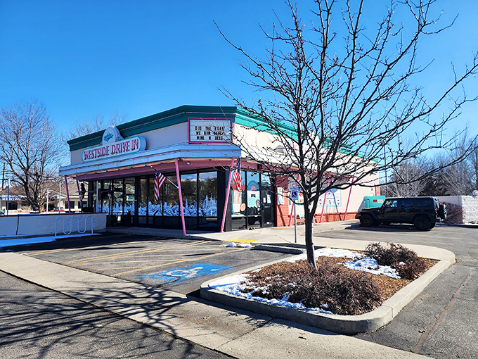 The pink and turquoise facade of Westside Drive In stands like a time capsule of Americana, beckoning hungry travelers with promises of comfort food perfection.