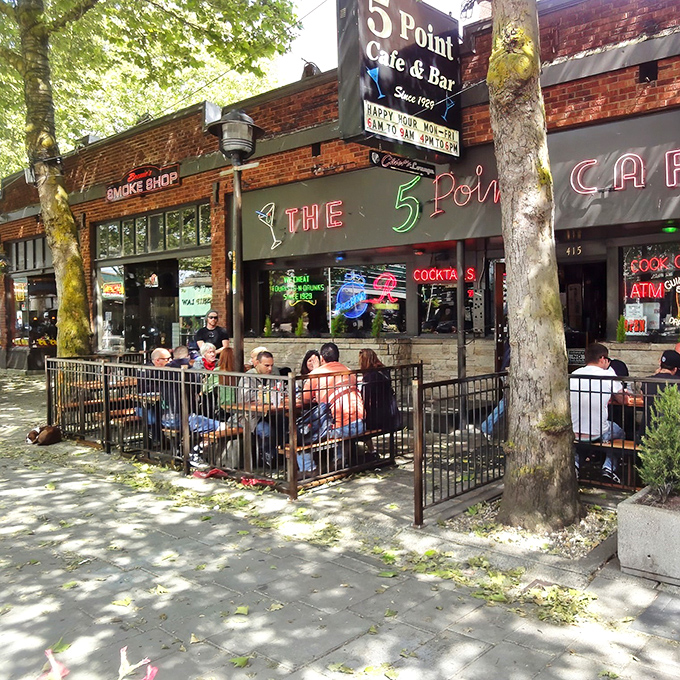The 5 Point's iconic brick exterior and neon signage beckons like an old friend, promising comfort food and zero pretension in Seattle's bustling Belltown neighborhood.