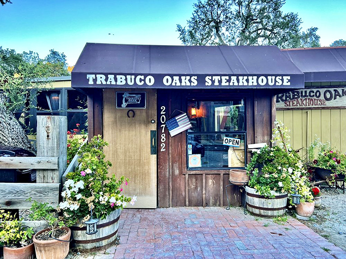 The unassuming wooden exterior of Trabuco Oaks Steakhouse promises rustic charm and serious steak business. Those barrel planters aren't just for show&mdash;they're your first hint of the no-nonsense authenticity waiting inside.