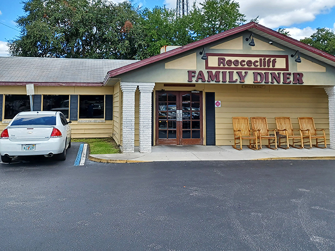 The unassuming yellow exterior of Reececliff Family Diner, with its wooden rocking chairs, promises comfort food magic that generations of Lakeland locals have treasured.