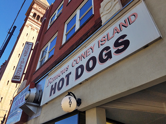 The iconic red and white sign beckons hungry travelers like a culinary lighthouse. "Famous Coney Island HOT DOGS" isn't just advertising&mdash;it's a promise kept for generations.