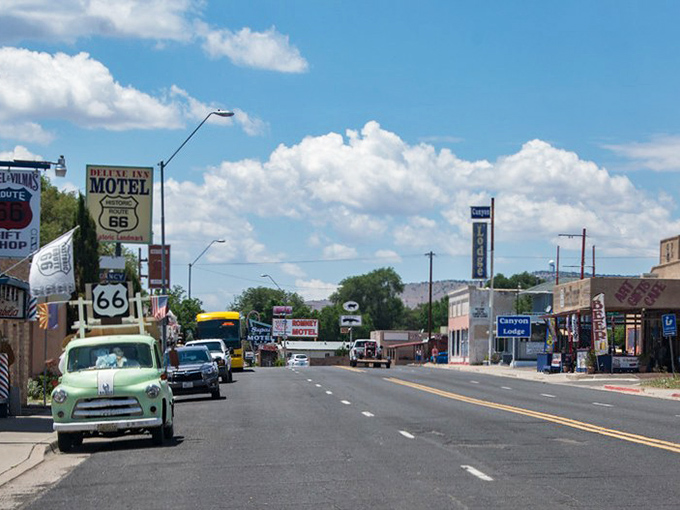 Route 66 stretches before you like a ribbon of possibilities, with Seligman's vintage storefronts standing as colorful sentinels of simpler times.