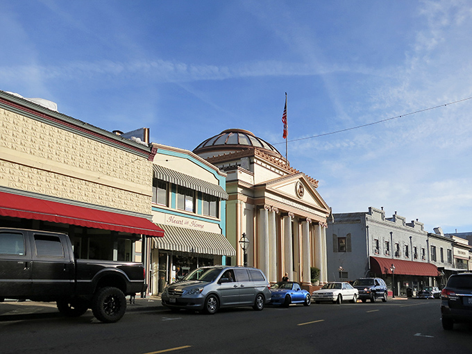 Historic buildings line Grass Valley's Main Street, their colorful facades creating a living museum where Gold Rush history and modern life dance together.