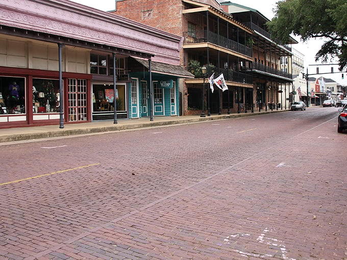 Brick streets and historic buildings—Natchitoches' Front Street feels like stepping into a time machine where modern cars look oddly out of place.
