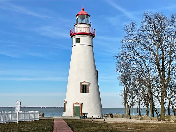 Standing tall since 1821, this gleaming white sentinel with its cherry-red cap has guided sailors through Lake Erie's treacherous waters for two centuries.