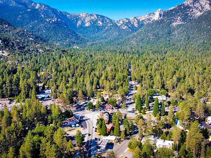 A bird's-eye view that makes you wonder if you've stumbled into a Bob Ross painting&mdash;pine-covered mountains embracing a tiny village like a verdant hug.