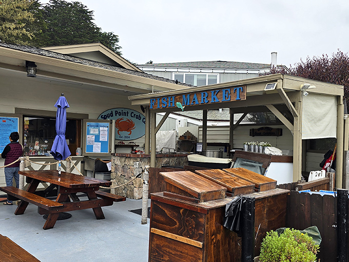 The unassuming exterior of seafood paradise. Wooden picnic tables and a simple sign promise treasures that fancy restaurants can only dream about.