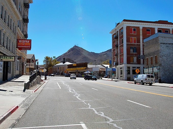 Main Street Tonopah greets visitors with historic brick buildings while fog dramatically embraces the mountain, like nature's own theater curtain rising on a mining town stage.