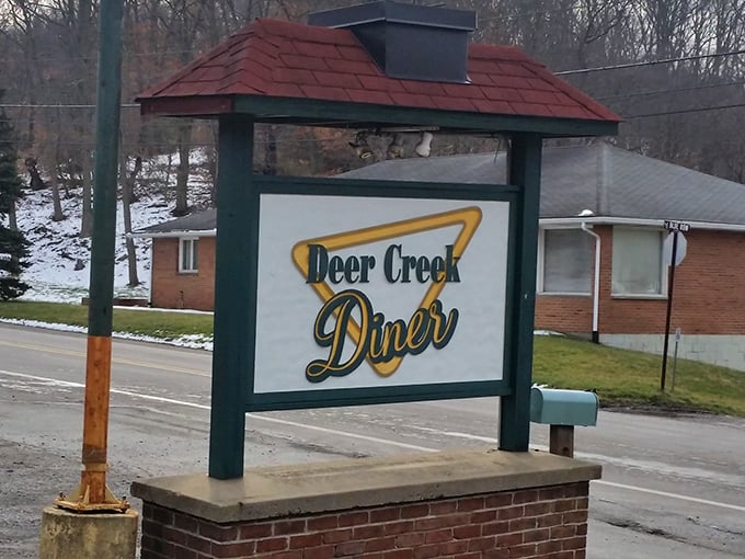 The iconic Deer Creek Diner sign stands as a beacon of breakfast hope along the roadside, promising comfort food salvation to hungry travelers.