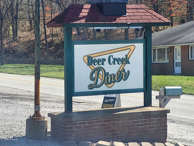 The iconic Deer Creek Diner sign stands as a beacon of breakfast hope along the roadside, promising comfort food salvation to hungry travelers.