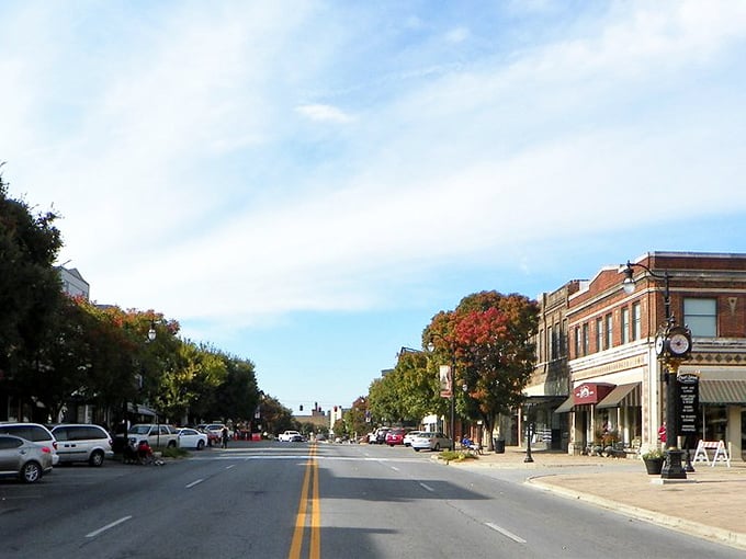 Broad Street stretches into the distance like a Norman Rockwell painting come to life, where autumn trees frame historic storefronts under Alabama's impossibly blue sky.