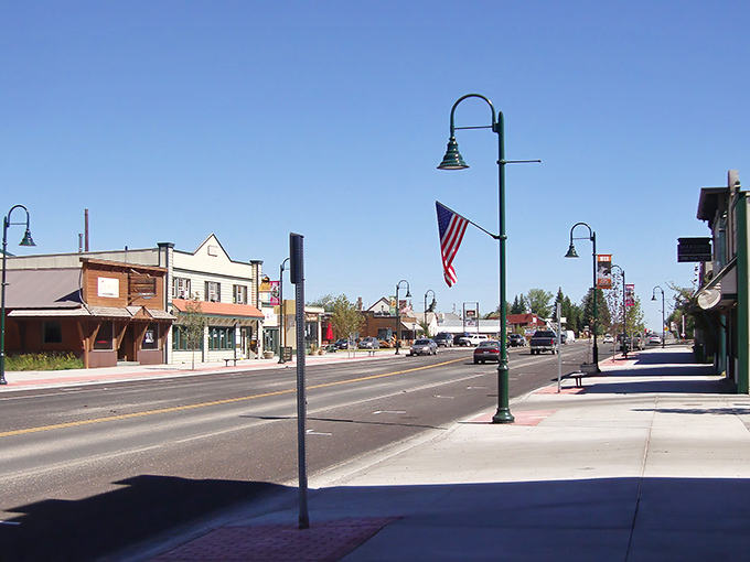 Main Street Driggs &ndash; where Norman Rockwell meets mountain majesty. Those green lampposts and American flags aren't just decoration; they're a promise of small-town authenticity.
