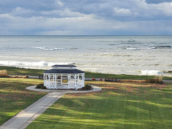 Lake Erie's moody blues meet architectural charm at this picturesque gazebo, where visitors gather to witness nature's daily watercolor masterpiece.