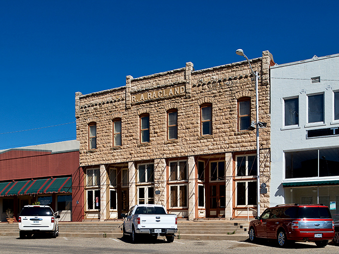 The iconic Sweetwater sign stands tall against that impossibly blue Texas sky, like a beacon calling weary wallets to the promised land of affordability.