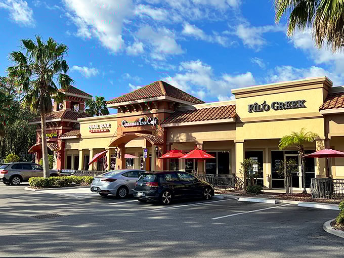 The unassuming strip mall exterior hides culinary treasures within, like finding a Picasso at a yard sale. Palm trees stand guard over flavor paradise.