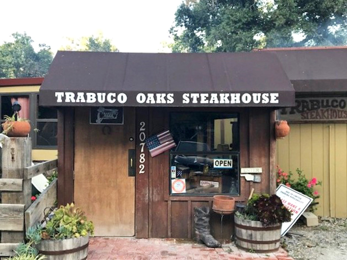 This rustic steakhouse exterior whispers "authentic" louder than a dinner bell at suppertime. 