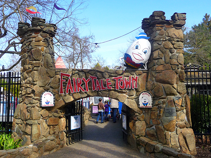 The stone archway entrance to Fairytale Town welcomes visitors with Humpty Dumpty perched above, proving some falls can lead to happy endings after all.