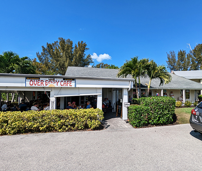 The unassuming exterior of Over Easy Cafe stands like a breakfast beacon on Sanibel Island, promising morning delights beneath the swaying palms.