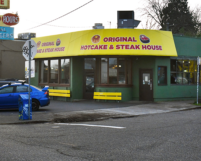 The unmistakable green and yellow exterior stands like a breakfast lighthouse on Powell Boulevard, beckoning hungry travelers at all hours.