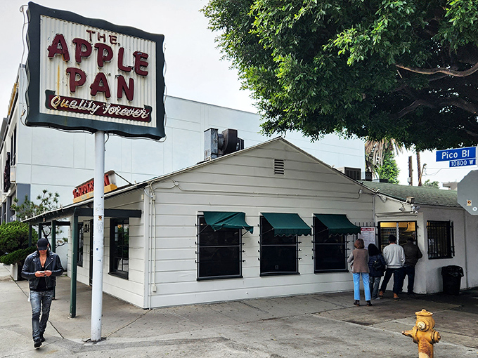 
The unassuming white building with its vintage sign promises "Quality Forever" &ndash; a bold claim that The Apple Pan has somehow managed to keep for decades.