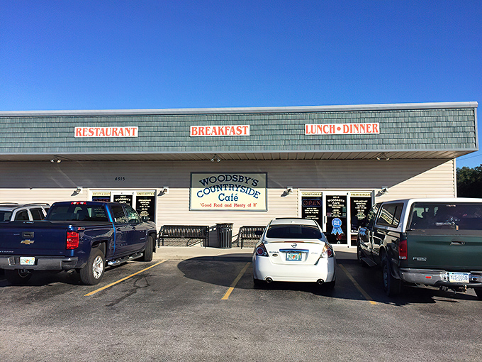 The unassuming exterior of Woodsby's Cafe might not scream "culinary destination," but locals know this blue-roofed treasure holds comfort food gold inside.