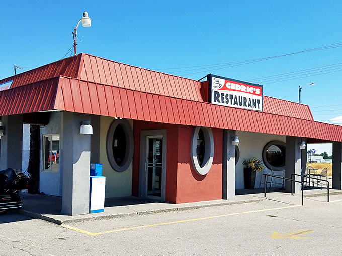 The iconic red-roofed diner with porthole windows stands like a culinary lighthouse for hungry travelers seeking comfort food perfection in Idaho Falls.