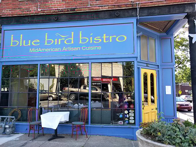 The bright blue storefront with its sunny yellow door stands like a cheerful beacon in Kansas City's Westside neighborhood, promising culinary adventures within.