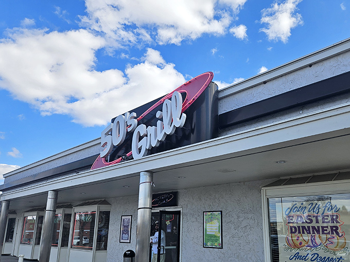 The retro red-and-white sign beckons like a time machine disguised as a restaurant. 50's Grill stands proudly against Minnesota's ever-changing skyline, promising comfort inside.