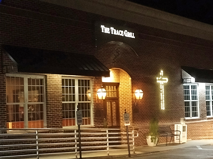 The unassuming brick exterior of The Trace Grill hides culinary treasures within, like a Southern speakeasy where the password is "comfort food."