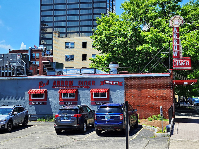 The iconic neon sign beckons hungry travelers like a lighthouse for the famished. This brick-and-mortar time machine has been Manchester's comfort food headquarters for generations.