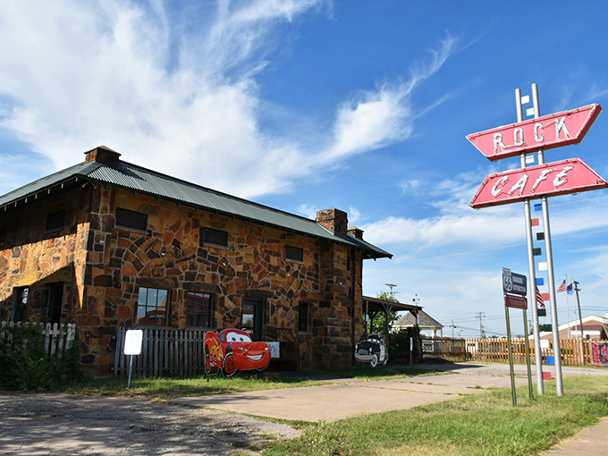 The iconic stone exterior of Rock Cafe stands as a Route 66 sentinel, complete with vintage car cutouts that practically wink at passing travelers.