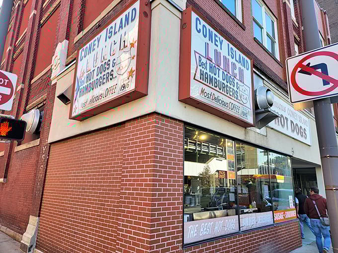 The iconic red and white sign beckons hungry travelers like a culinary lighthouse. "Famous Coney Island HOT DOGS" isn't just advertising&mdash;it's a promise kept for generations.