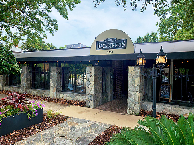 The stone facade of Backstreets Grill welcomes hungry travelers like an old friend who knows exactly what you need after a long day.