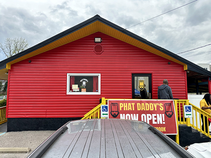 The vibrant red exterior of Phat Daddy's on Da Tracks stands out like a culinary beacon, promising flavor adventures from its humble Charleston hillside perch.