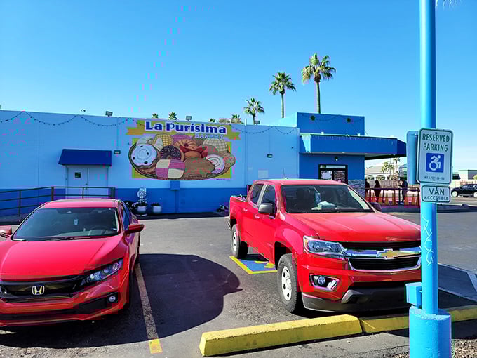 The blue and white exterior of La Purisima stands like a desert oasis, promising authentic Mexican flavors beneath the watchful Arizona palms.