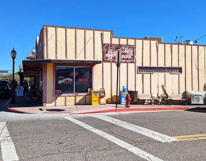 The yellow and red facade of Horseshoe Cafe stands like a beacon of breakfast hope on Wickenburg's main street, promising culinary comfort within those Western-themed walls.