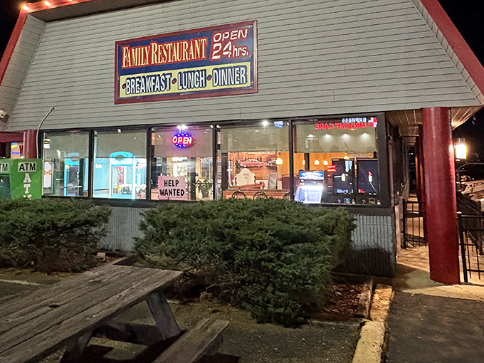 The neon glow of "OPEN 24 hrs" isn't just a sign&mdash;it's a beacon of hope for hungry souls at any hour. Classic diner architecture with a promise of comfort inside. 