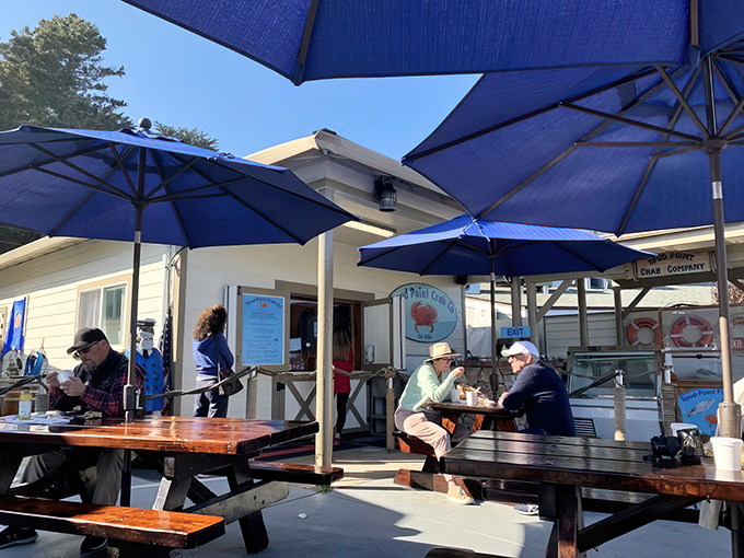 The unassuming exterior of seafood paradise. Wooden picnic tables and a simple sign promise treasures that fancy restaurants can only dream about.